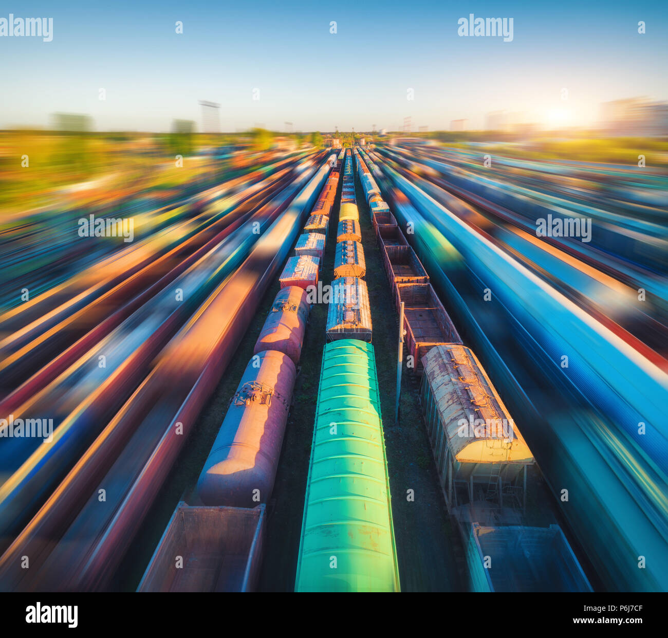 Aerial view of colorful freight trains at sunset. Cargo wagons with ...