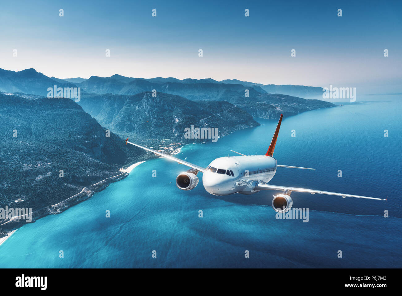 Aircraft is flying over islands and sea at sunrise in summer. Landscape ...
