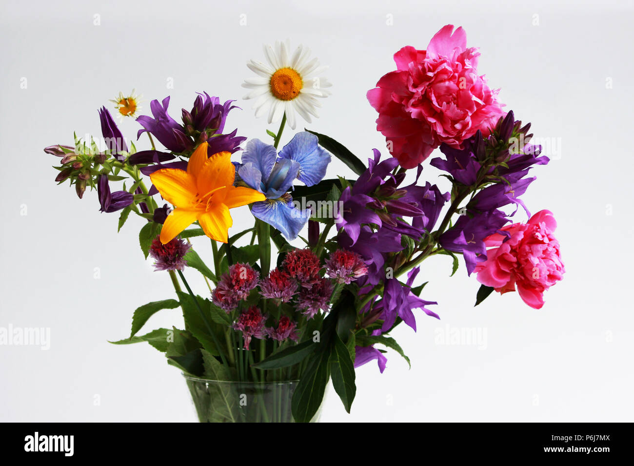 a bouquet of different wild field and garden flowers: chamomile, bell ...