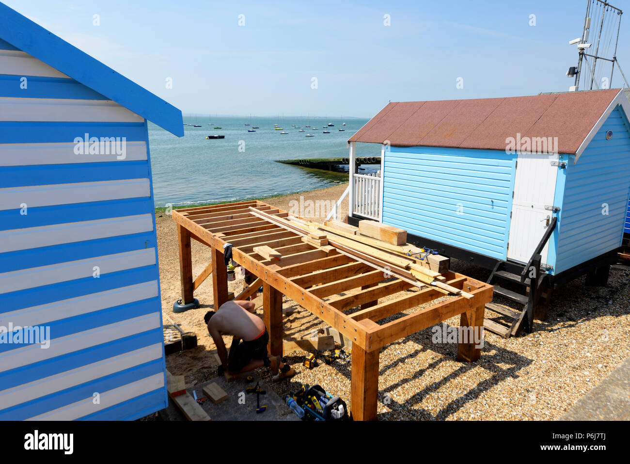 Workmen building a new beach hut in a row of huts at Thorpe Bay ...