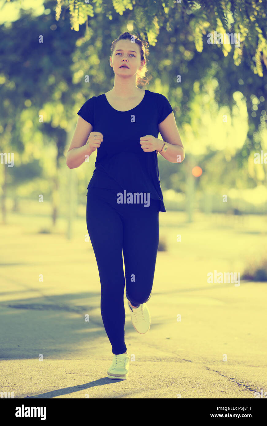 Sporty svelte girl jogging during outdoor daily workout Stock Photo - Alamy