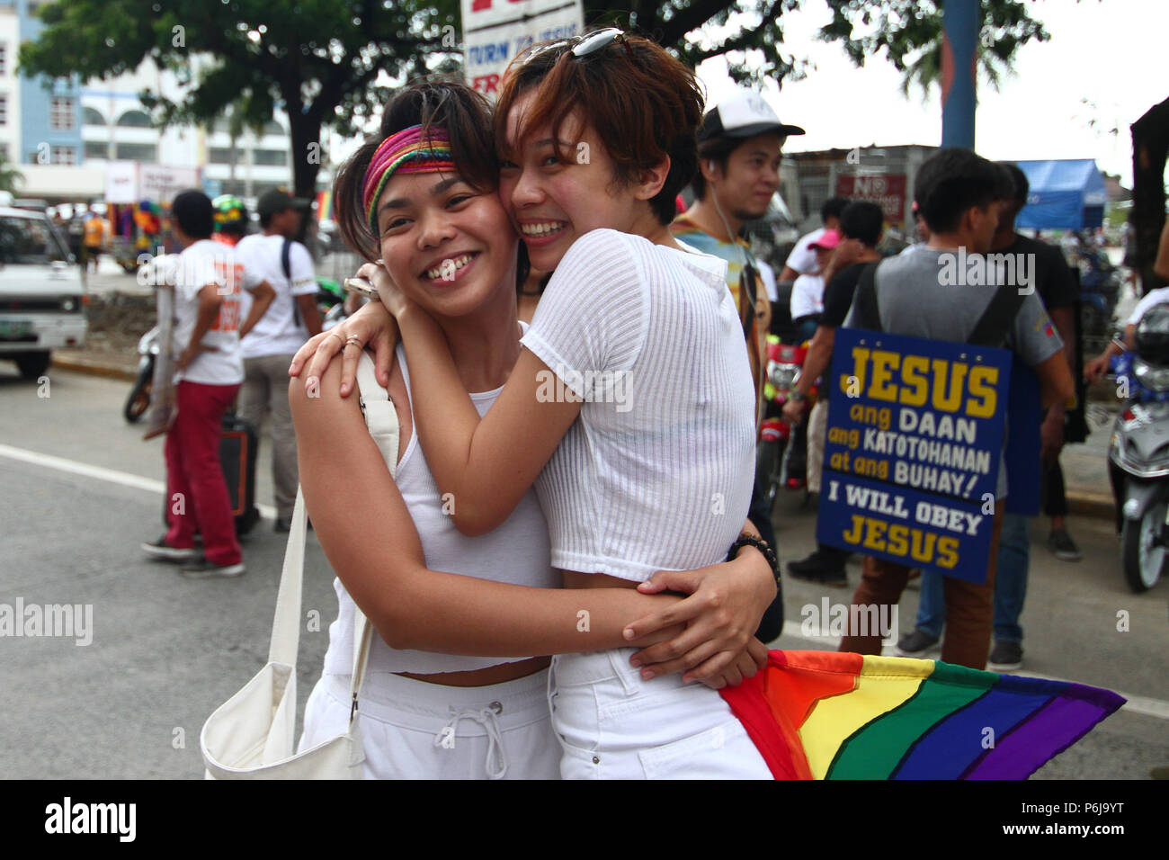 Philippines. 30th June, 2018. An LGBT couple hugs and smiles during the ...
