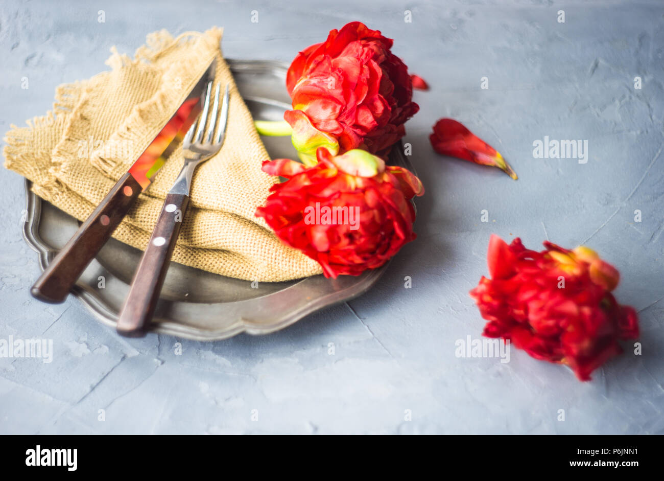 Summer table setting decorated with Red Princess tulips on rustic ...