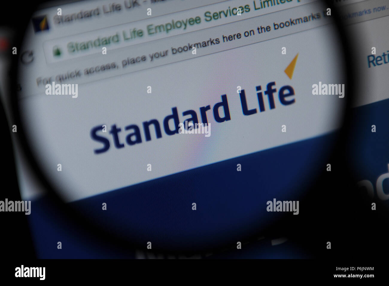 The Standard Life website seen through a magnifying glass Stock Photo ...