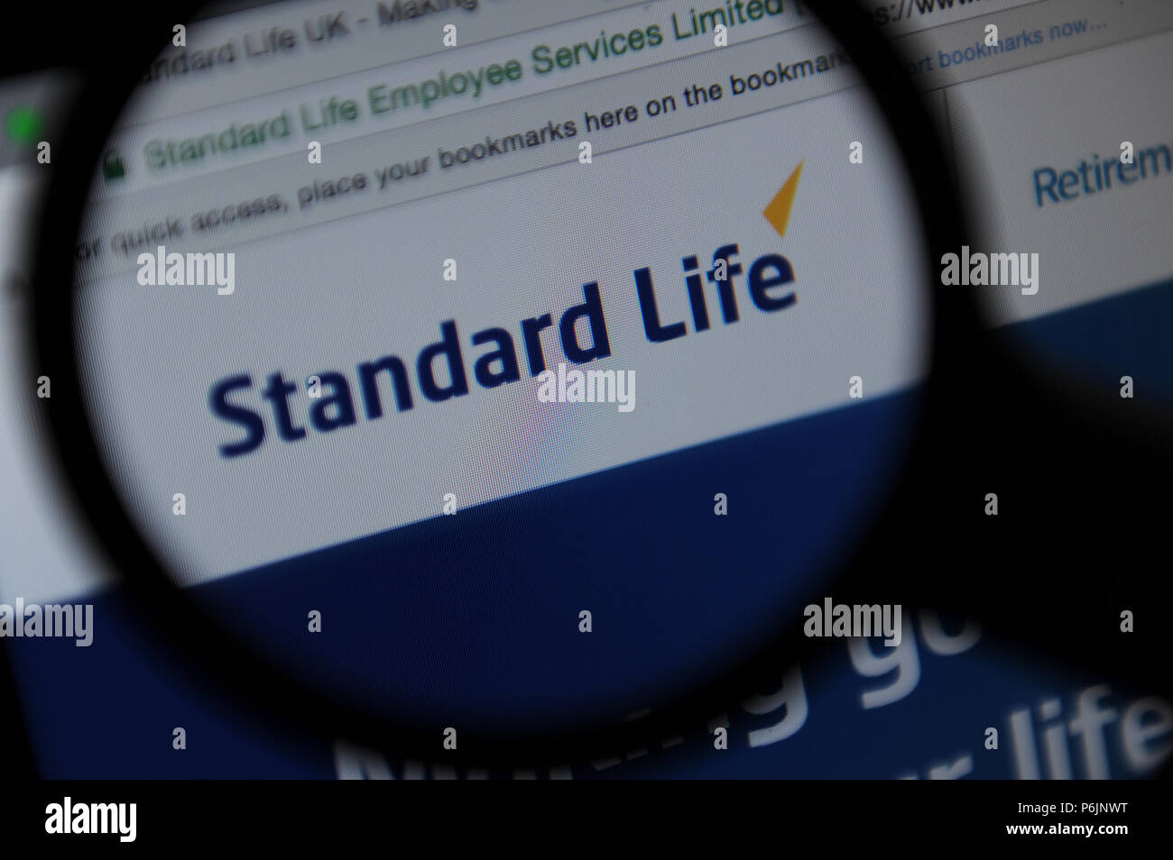 The Standard Life website seen through a magnifying glass Stock Photo ...