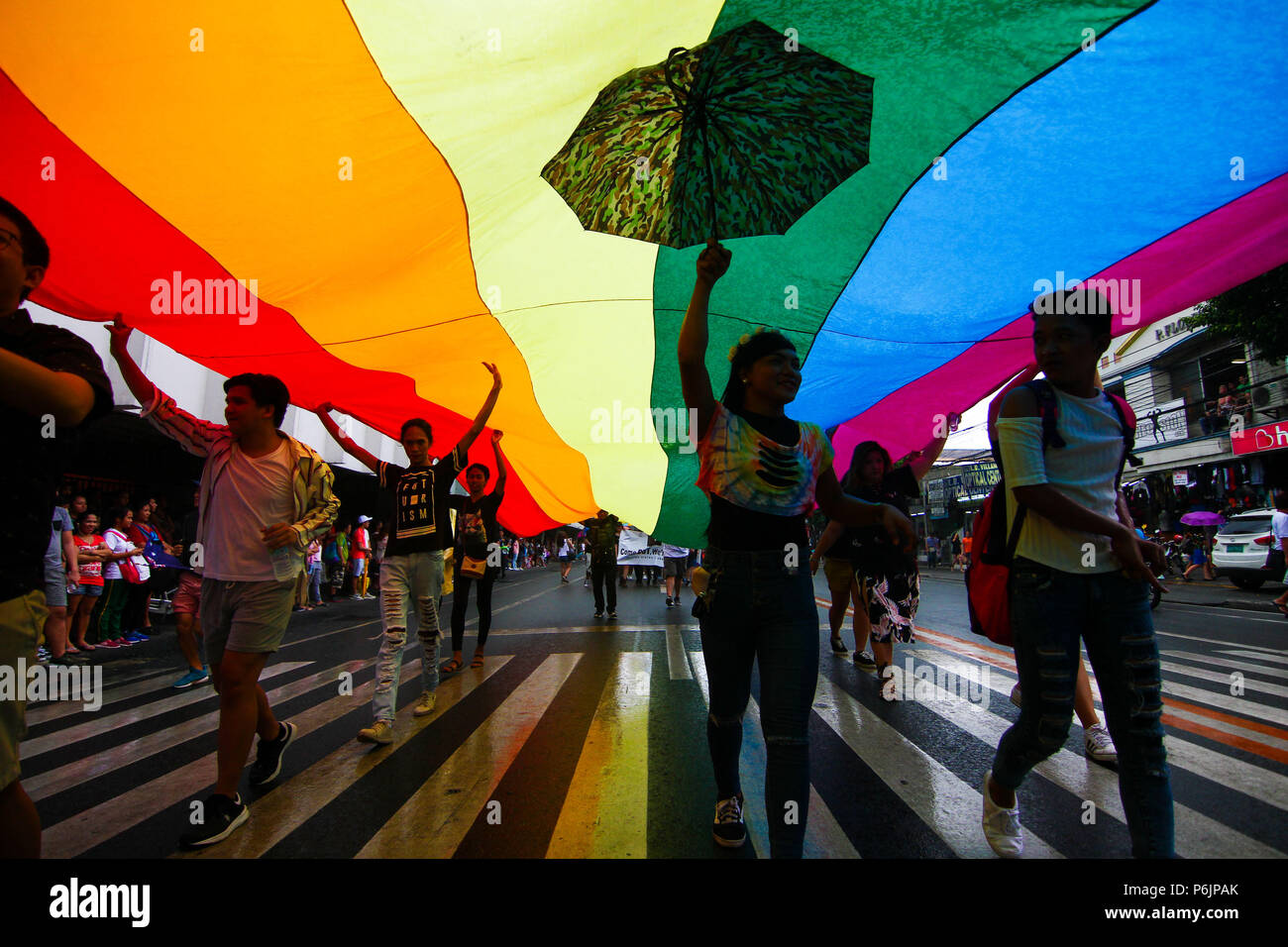 Pride march participants hold a rainbow flag during the parade ...