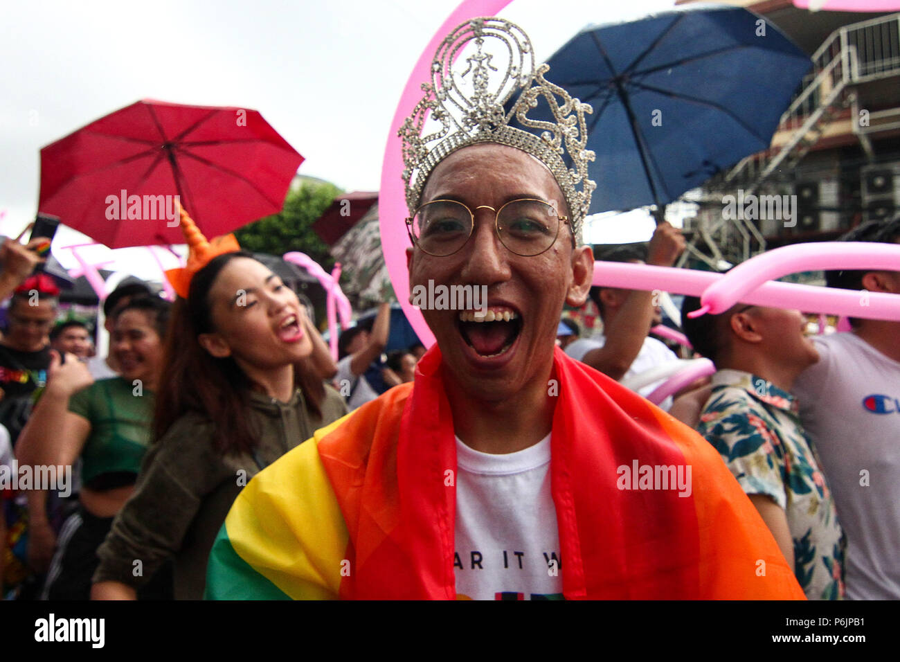 A pride march participant wearing a colorful costume. Thousands of gay ...
