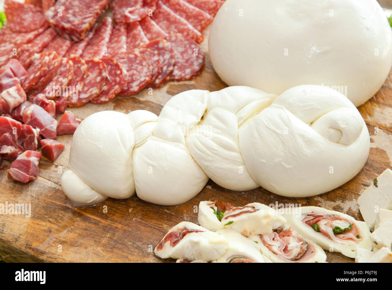 Mozzarella shaped braid on cutting board with salami and cheese Stock ...