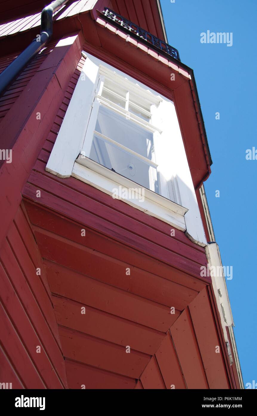 Red wooden exterior with white windows Stock Photo - Alamy