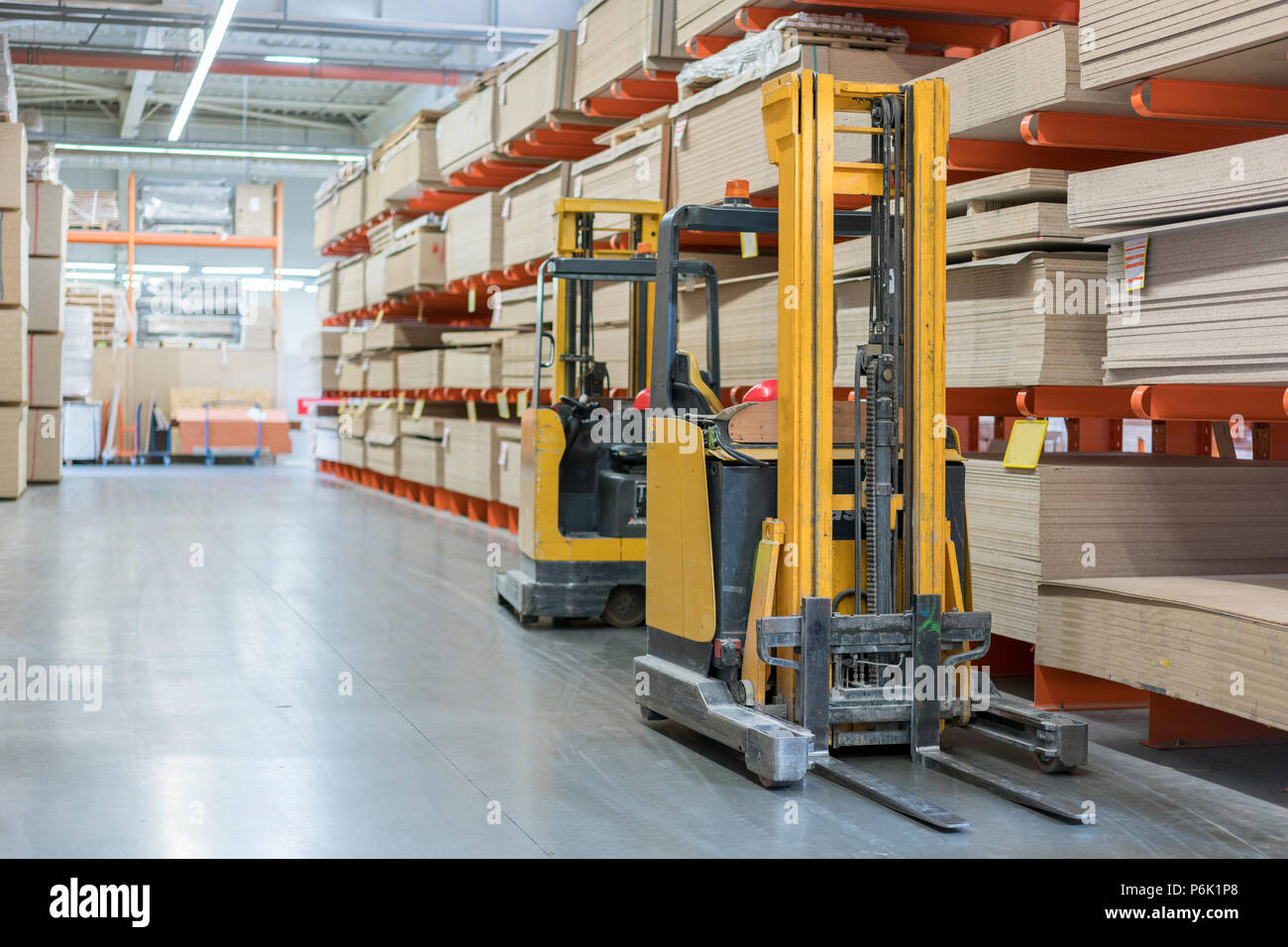 forklift in a construction shop. Construction Materials. Stacking truck ...