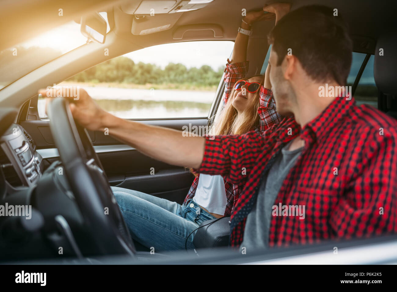Couple sitting in the car listening to music and having fun. Enjoy a ...
