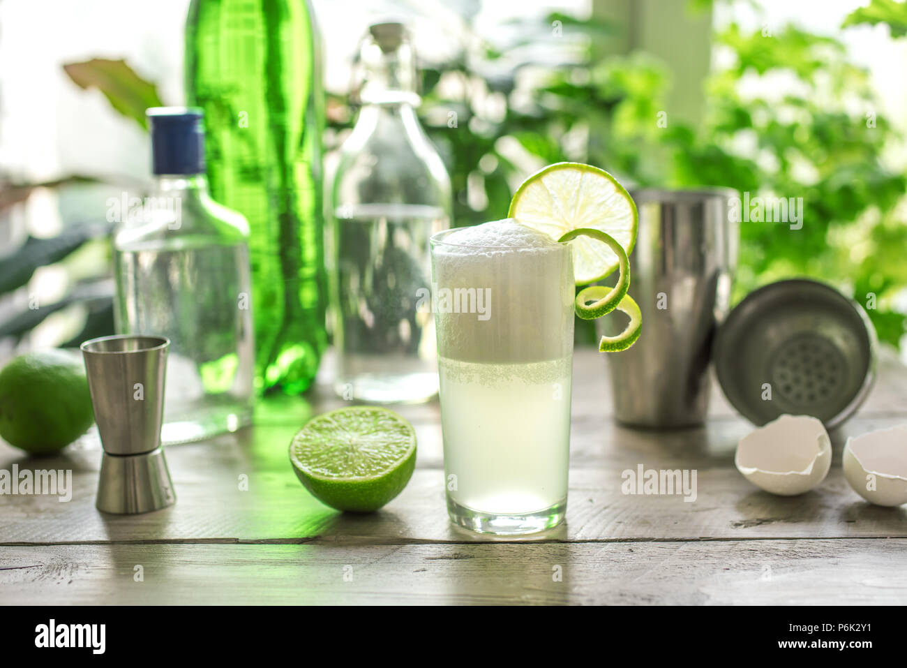 Egg Gin Fizz Cocktail with Lime Garnish. Making Gin Fizz Drink with ...
