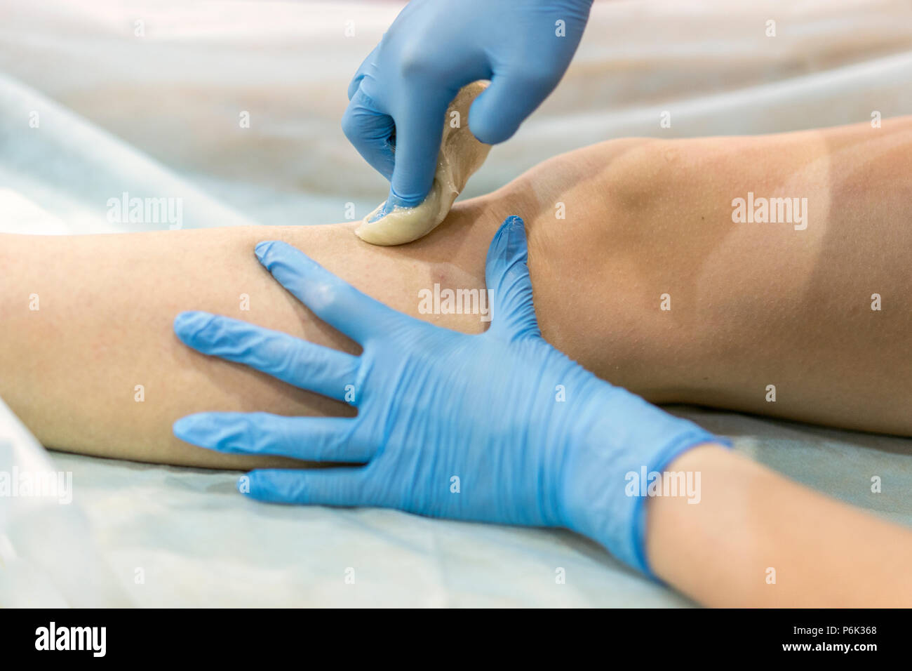process of legs depilation by sugar for women in beauty salon Stock ...