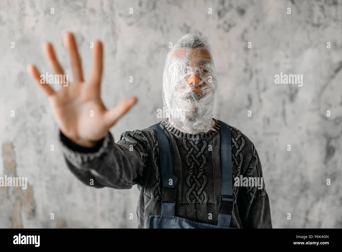 Autistic wraps his head in packaging film and pulls out his hand ...
