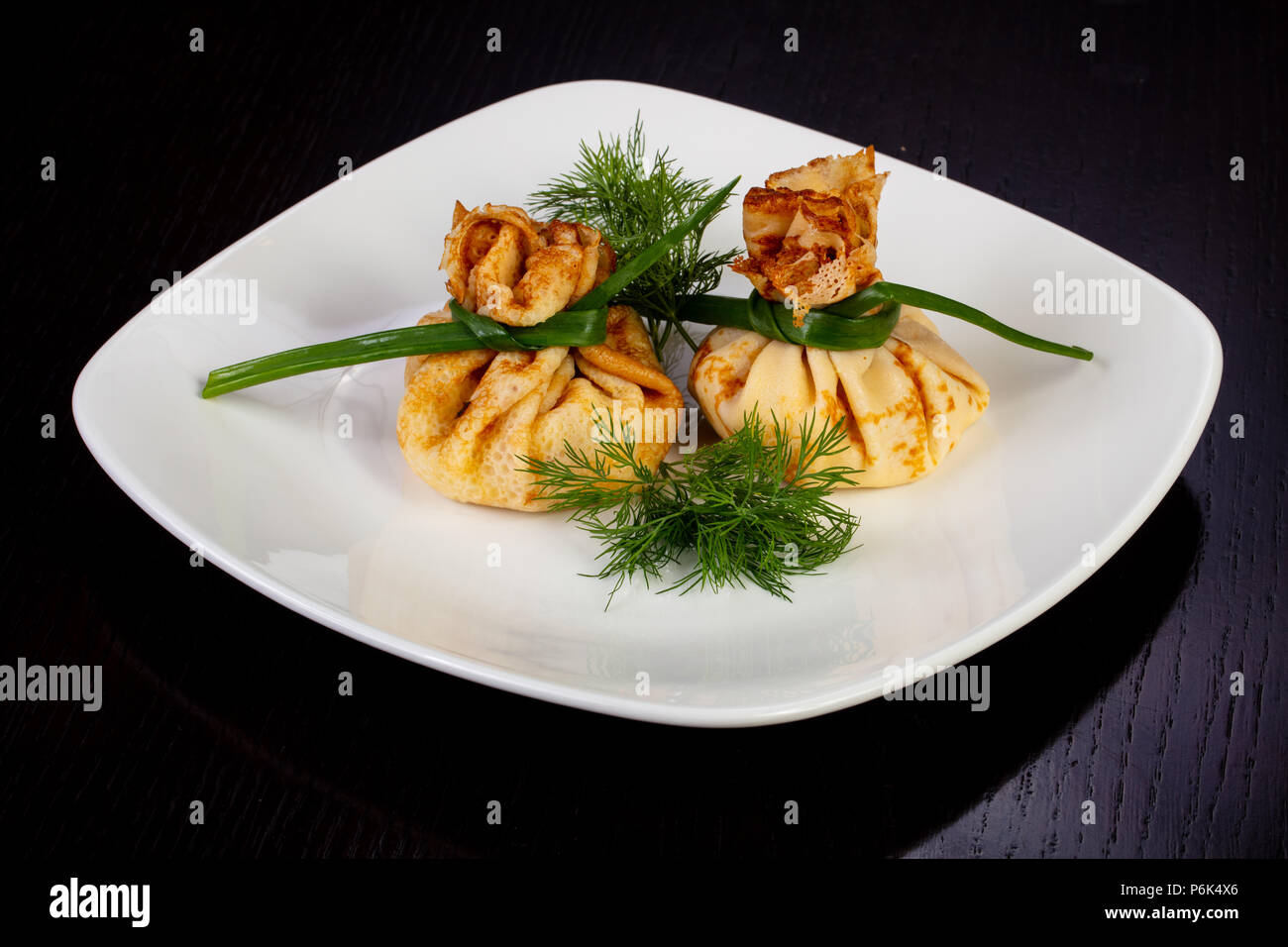 Delicious pancake bag with chicken Stock Photo - Alamy