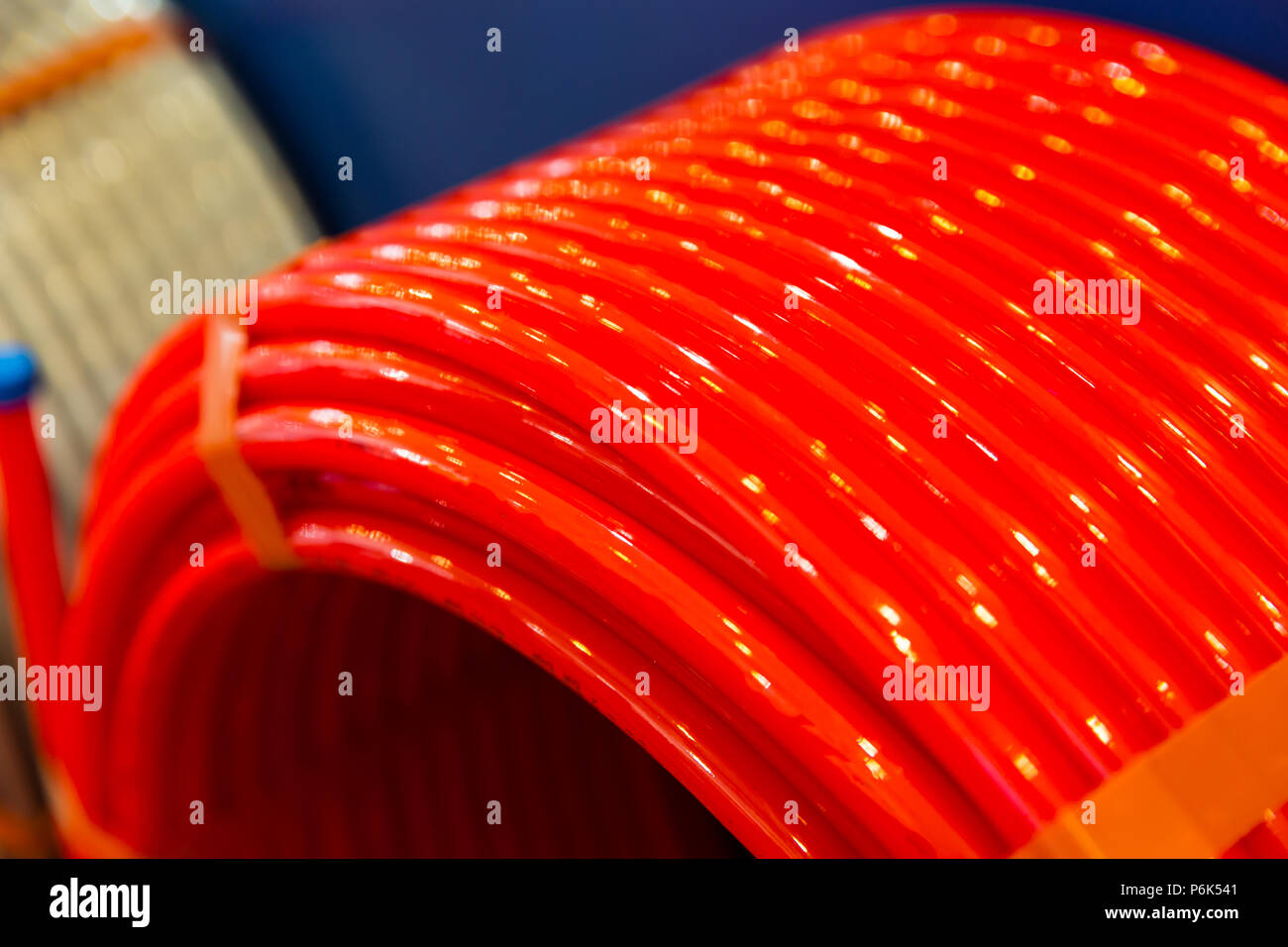 Roll of of red plastic pipe in plumbing shop, pvc. Coil of new water ...