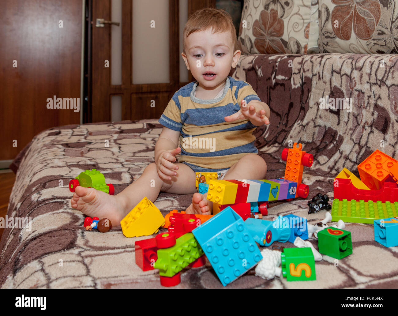 Sweet little boy building tower from cubes at home Stock Photo - Alamy
