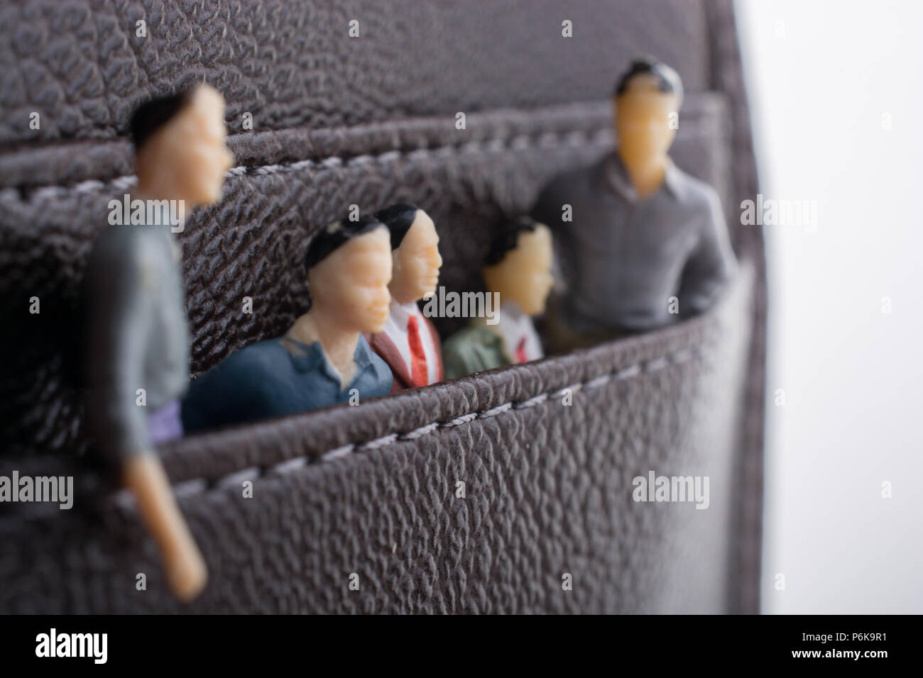 Tiny figurine of group of men miniature model in pockets Stock Photo ...