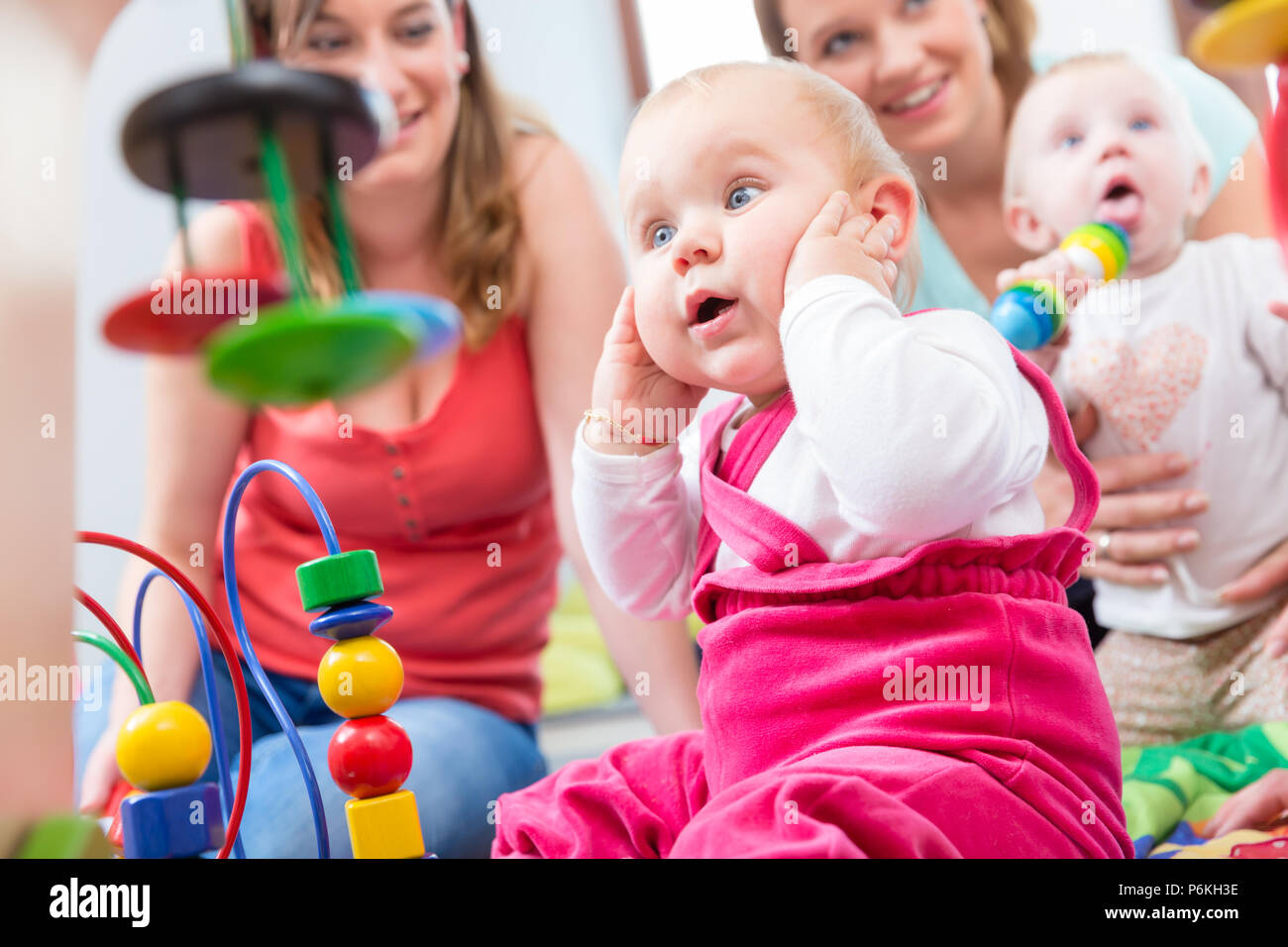 Cute baby girl showing progress and curiosity Stock Photo - Alamy