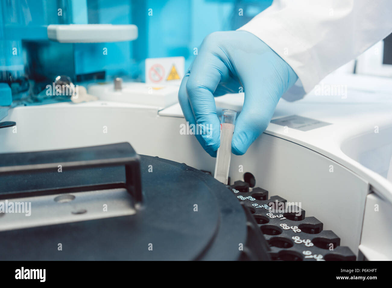 Doctor putting tubes of blood in centrifugal machine for testing Stock ...