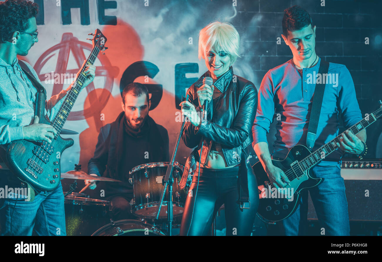 Band playing on stage making music Stock Photo - Alamy