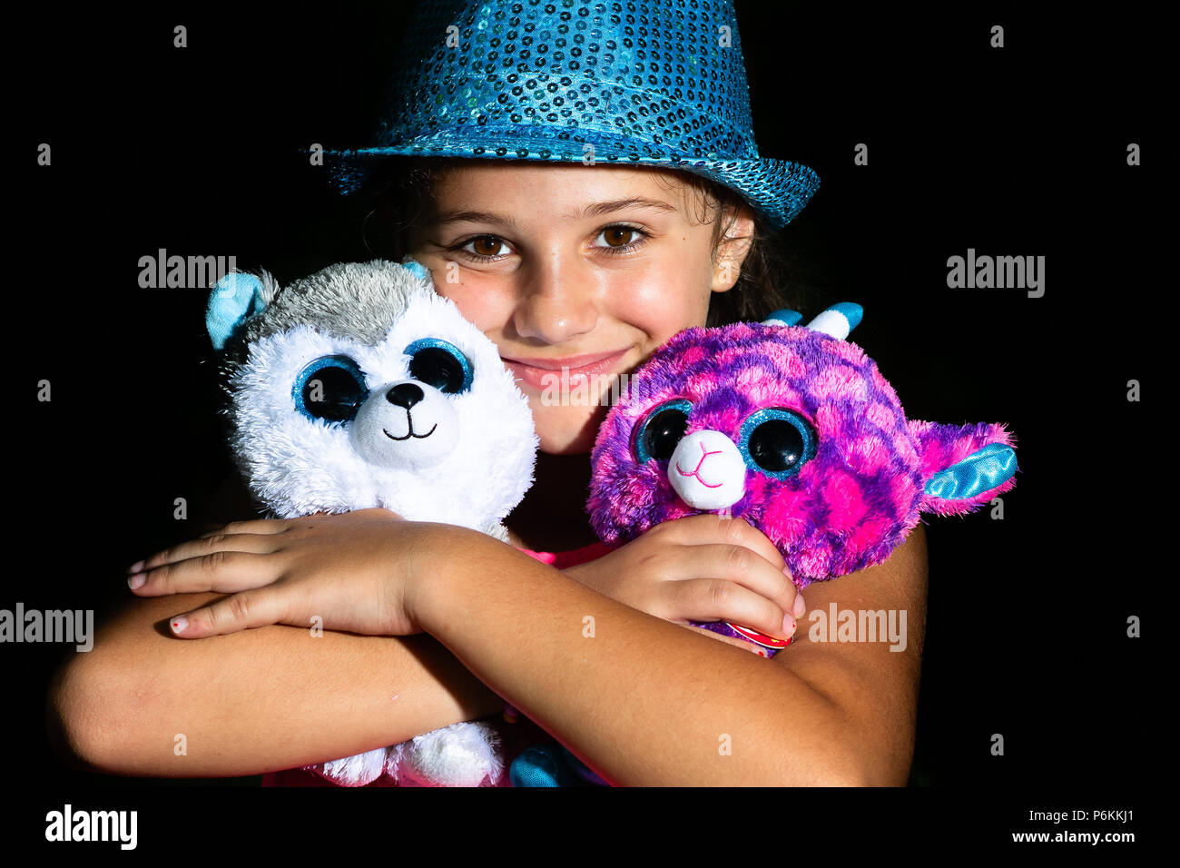 A little girl with two soft toys Stock Photo - Alamy