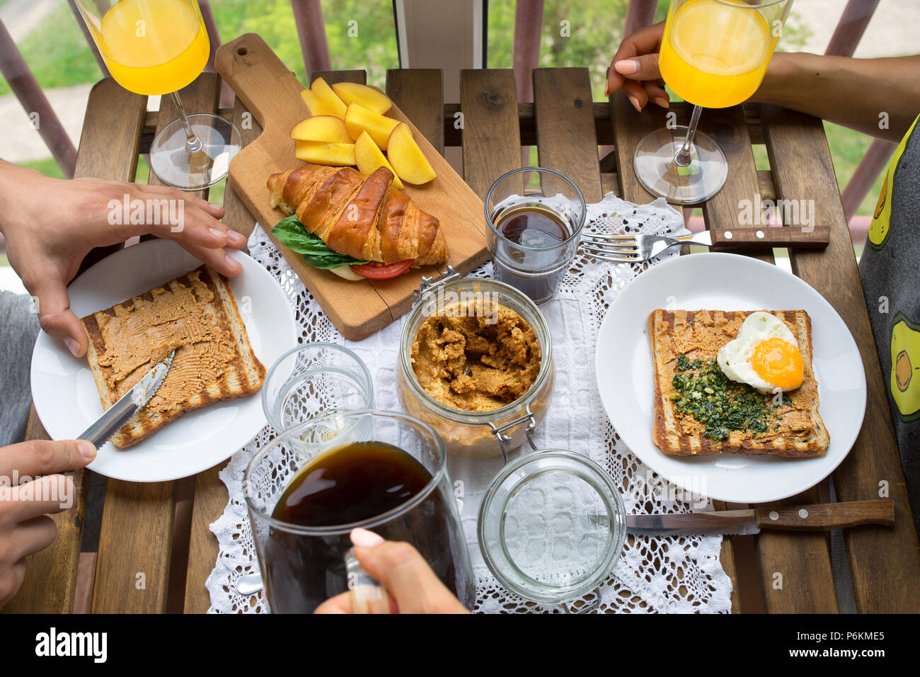 Couple having Breakfast on the balcony. Breakfast with toast, jam and ...