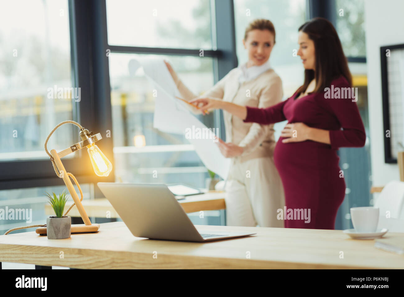Clever engineers looking at schemes and talking Stock Photo - Alamy