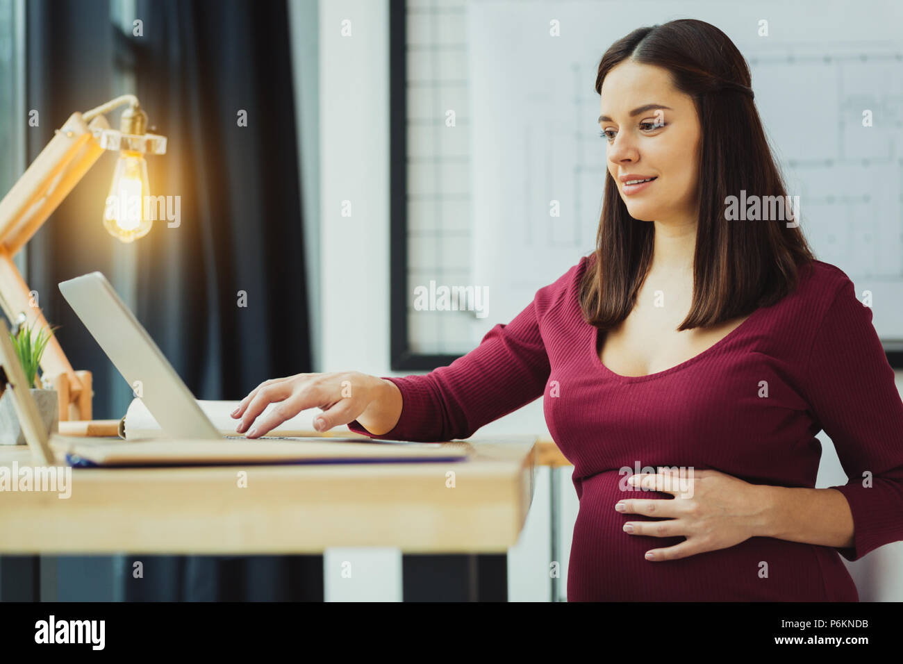 Clever young manager working while being pregnant Stock Photo - Alamy