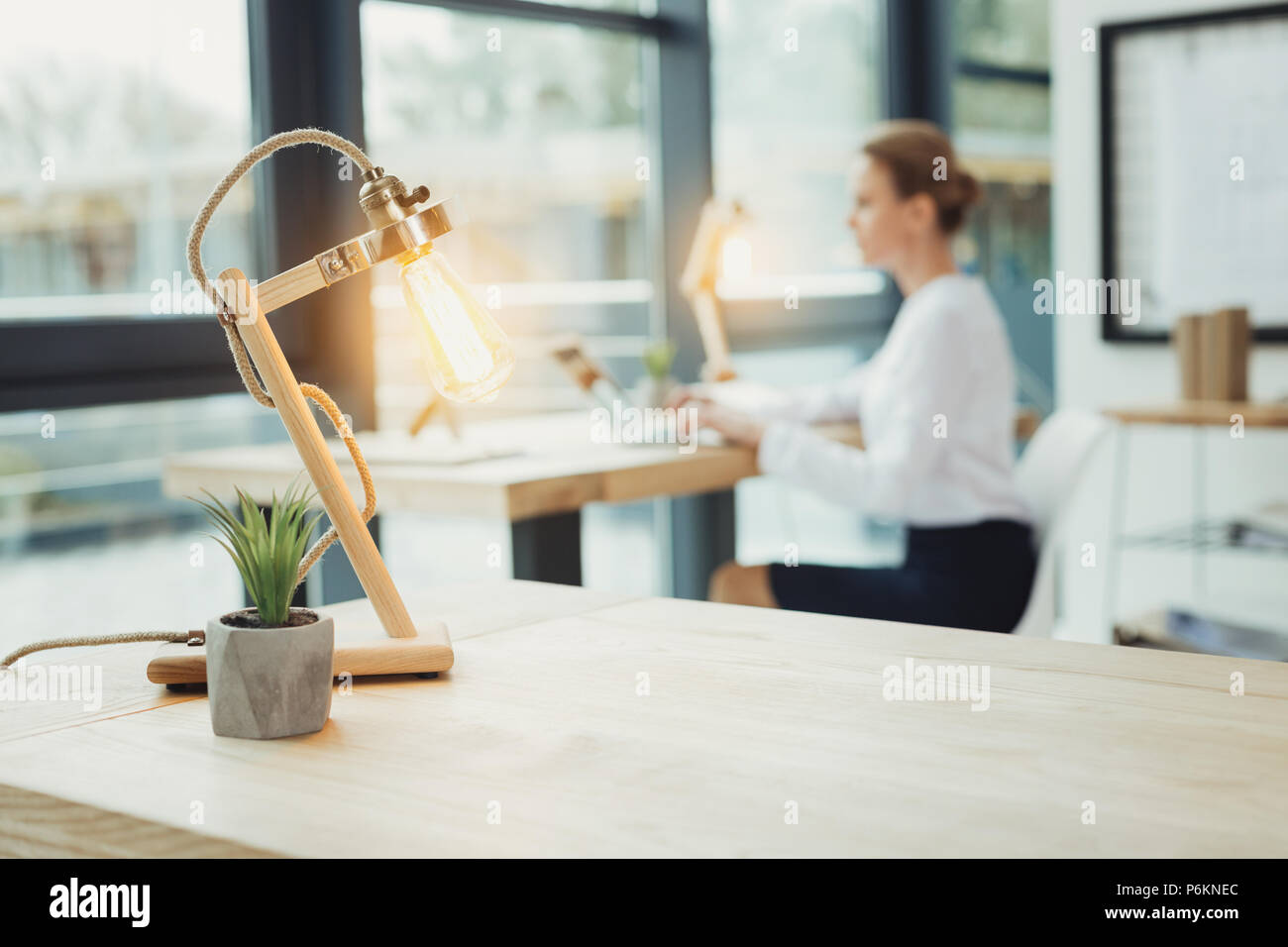 Calm young woman sitting in a comfortable office and working Stock ...