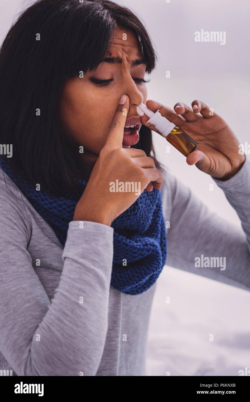 Unhealthy female person trying to drop nose Stock Photo - Alamy