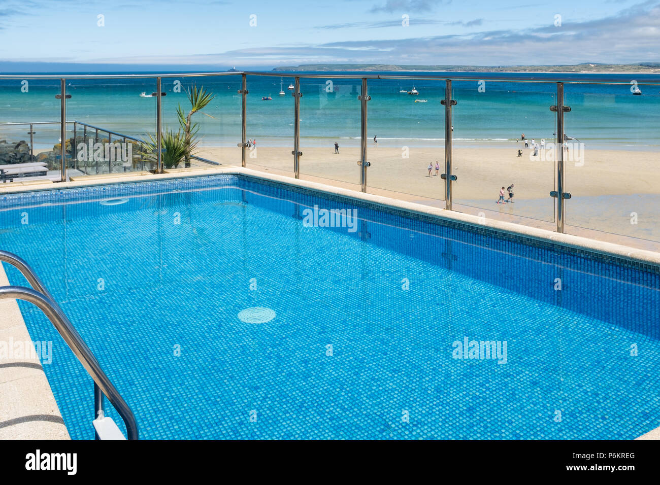 ST IVES, ENGLAND - JUNE 18: A vibrant blue hotel swimming pool at the ...