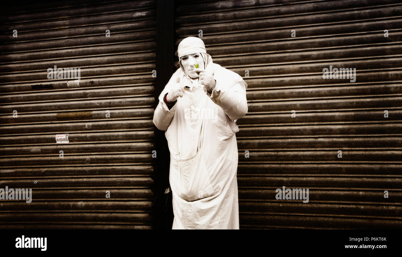 Photograph of a white faced mummified man dressed in bandages standing ...