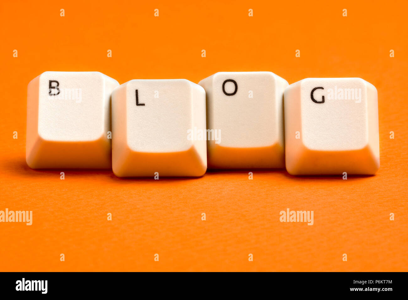 Blog word formed with real white keyboard keys on orange background ...