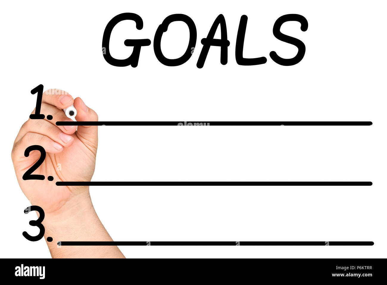 Hand is about to write first goal with black felt-tip or marker on ...