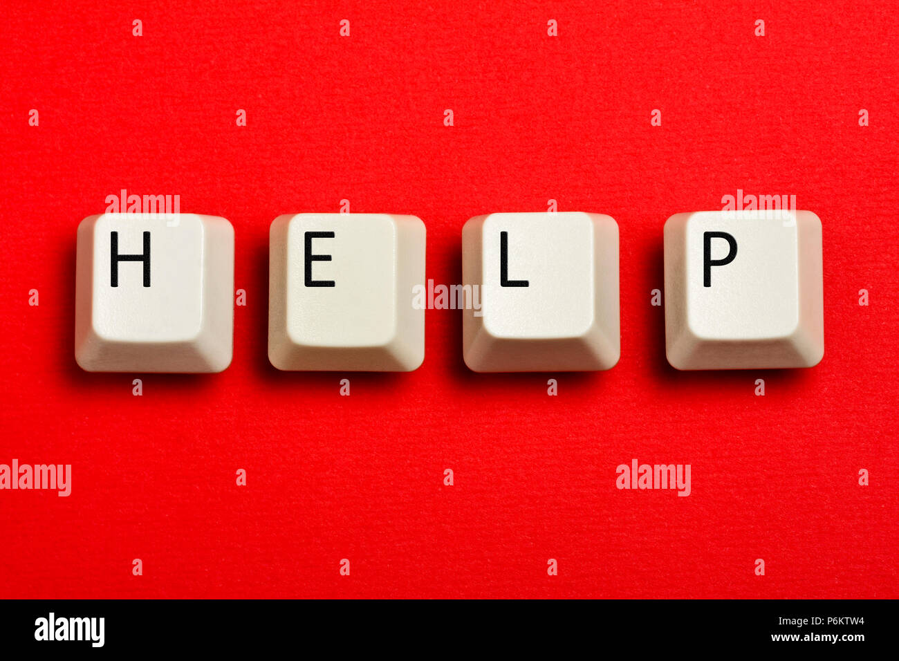 Help word with white keyboard keys on red background Stock Photo - Alamy