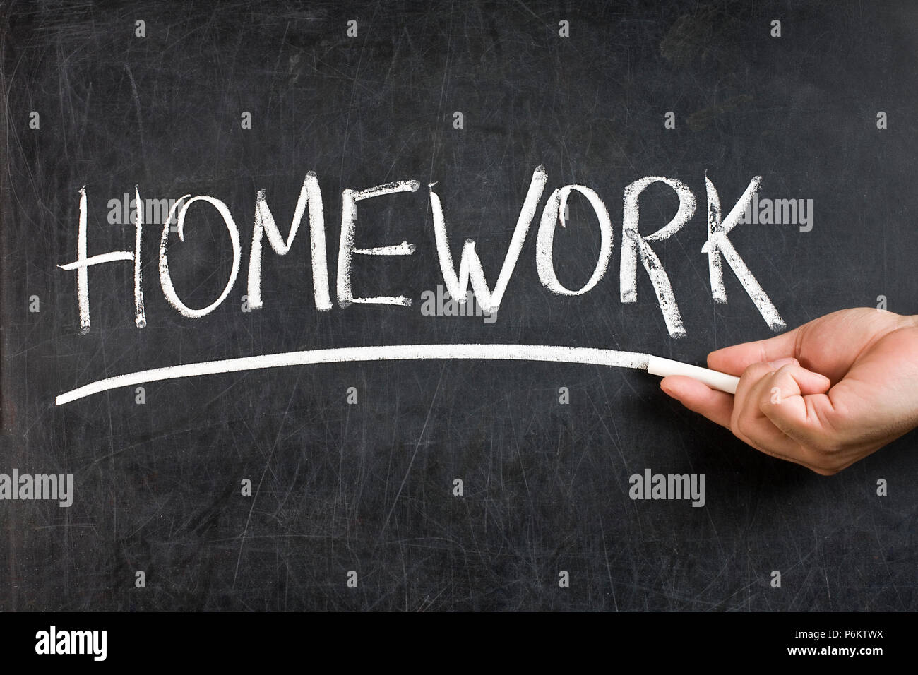 Teacher male hand with white chalk underlining handwritten homework ...