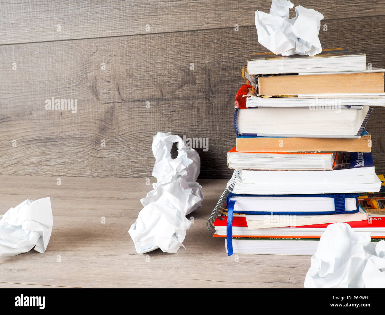 Still life with crumpled paper on books page and books stack background ...