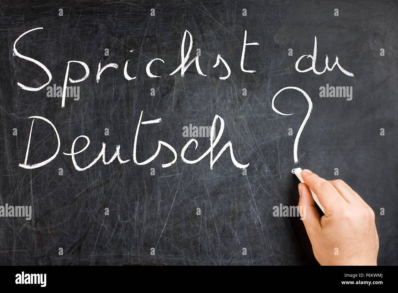 Do you speak German question handwritten on dirty chalkboard by male ...