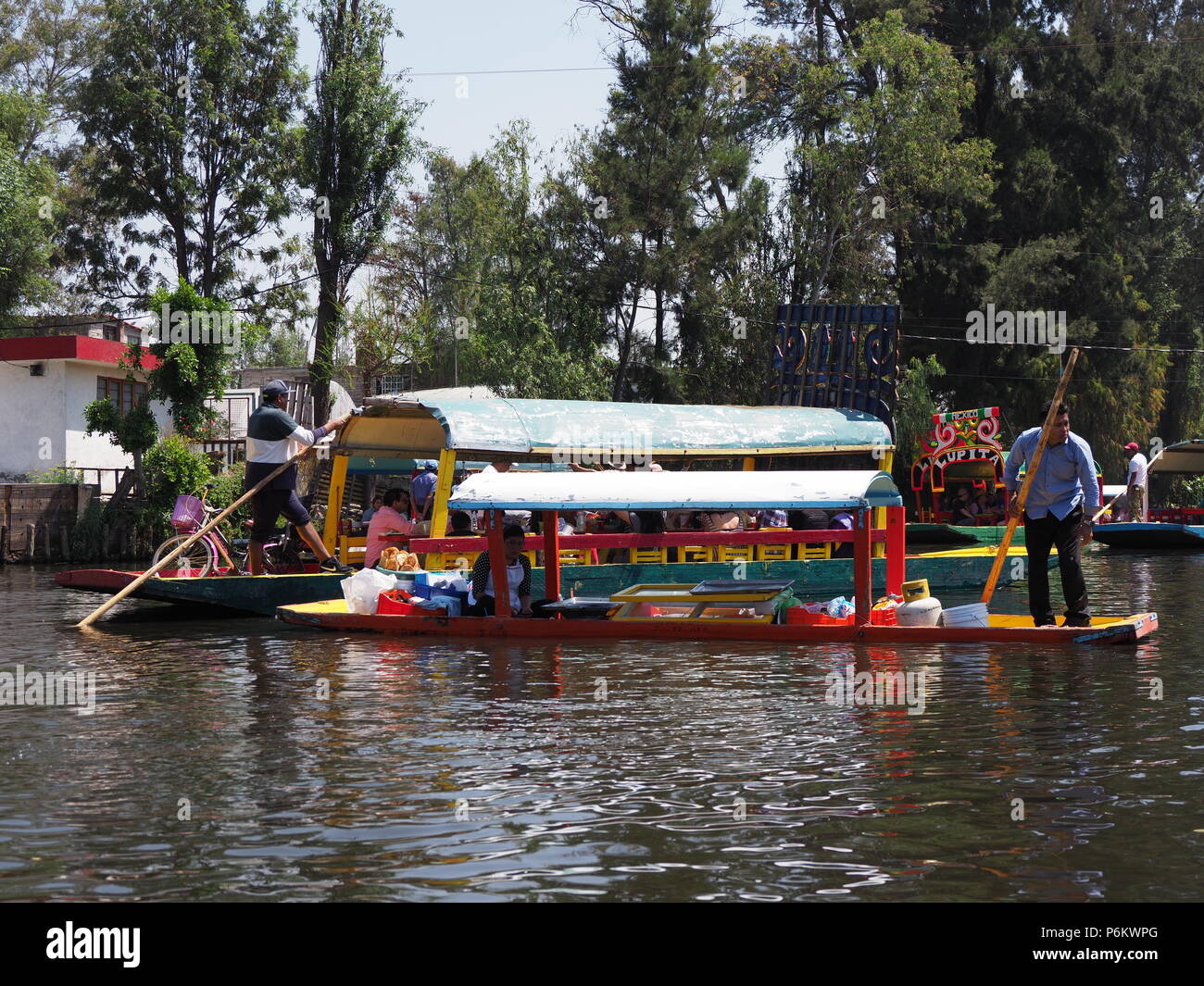 Famous colorful mexican boats with tourists and gondoliers at ...