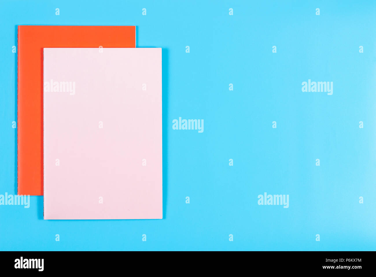 Colorful notebooks on blue background Stock Photo - Alamy