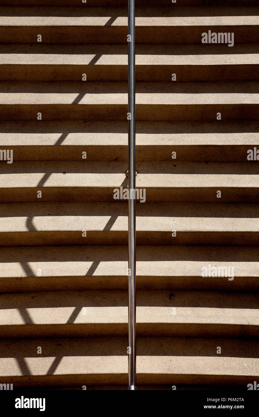 high up view looking down at the stairs and stair rail in a very ...