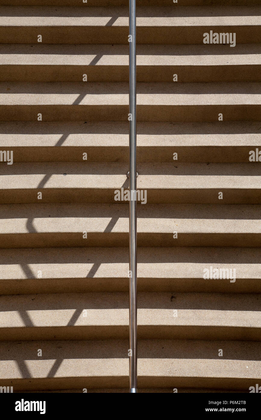 high up view looking down at the stairs and stair rail in a very ...