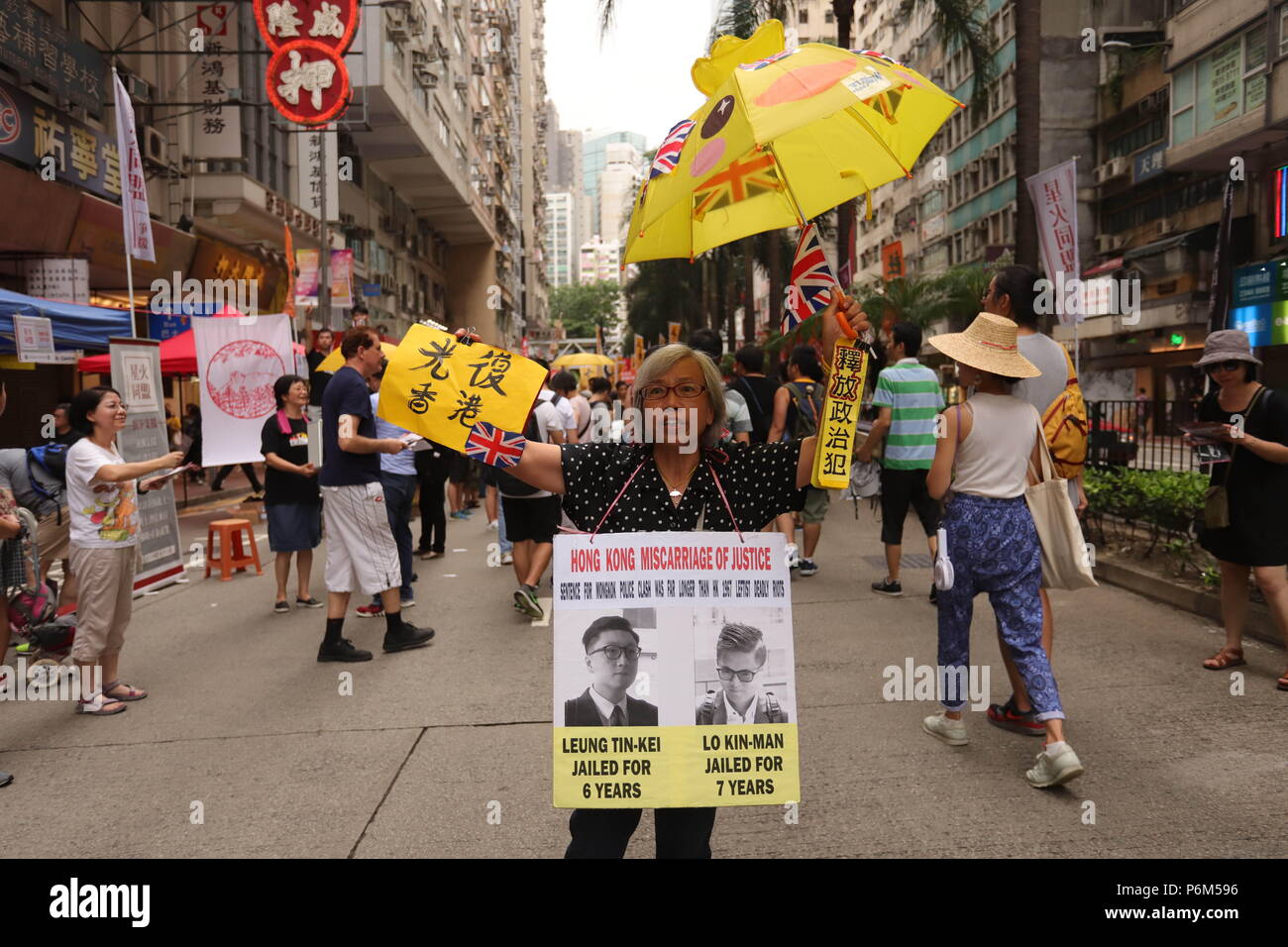 Hong Kong, CHINA. 1st July, 2018. A woman raise YELLOW UMBRELLA, a ...