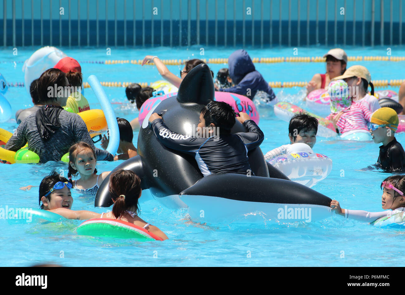 Tokyo, Japan. 30th June, 2018. People enjoy in a swimming pool as the ...