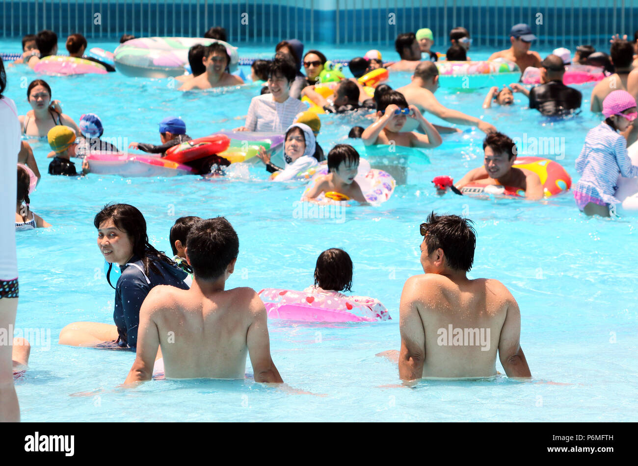 Tokyo, Japan. 30th June, 2018. People enjoy in a swimming pool as the ...