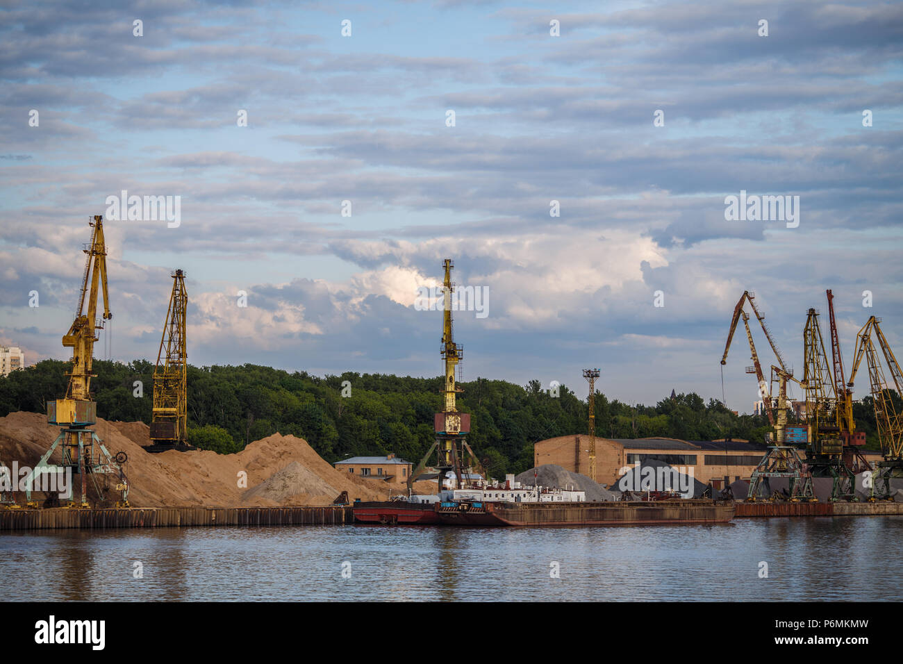 Loading and unloading of sand by crane Stock Photo - Alamy