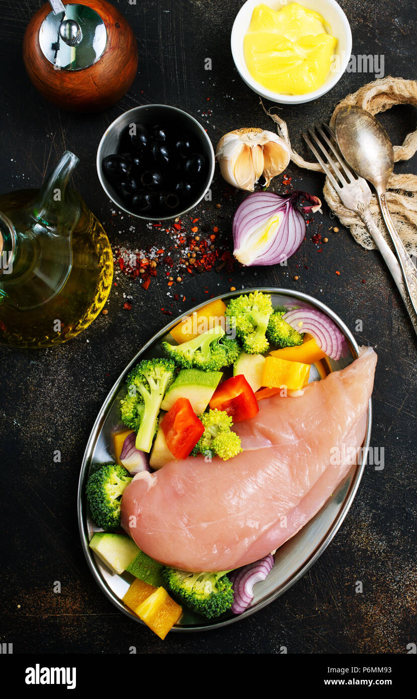 raw chicken fillet with fresh vegetables on plate Stock Photo - Alamy