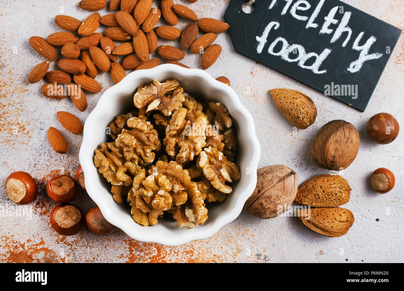 Mix nuts on beton background. Cut nuts Stock Photo - Alamy