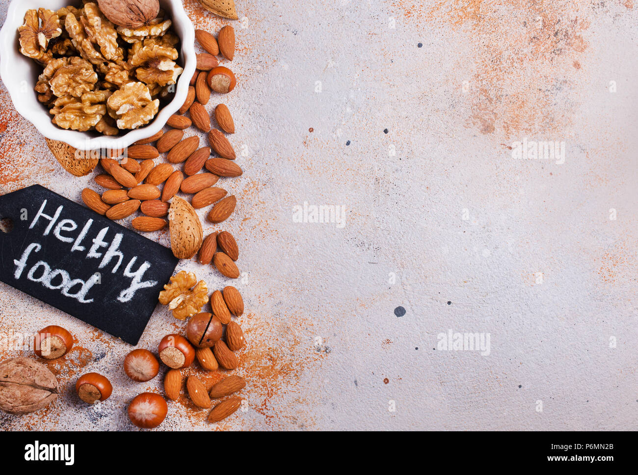 Mix nuts on beton background. Cut nuts Stock Photo - Alamy
